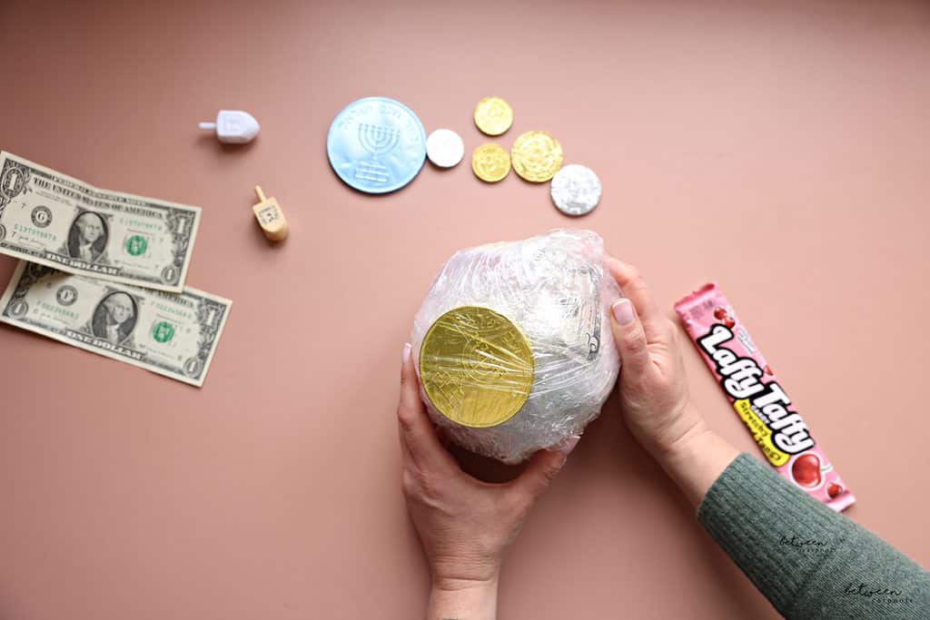 Make a Prize Ball Using Saran Wrap - Between Carpools
